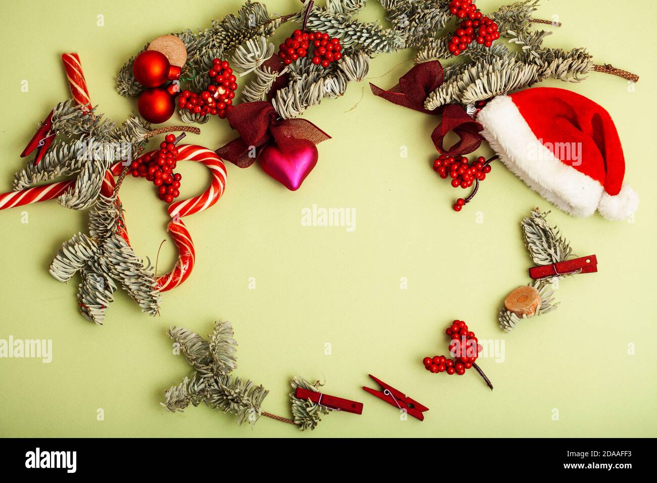 christmass stuff laying flat on colorful background, branch of tree ...