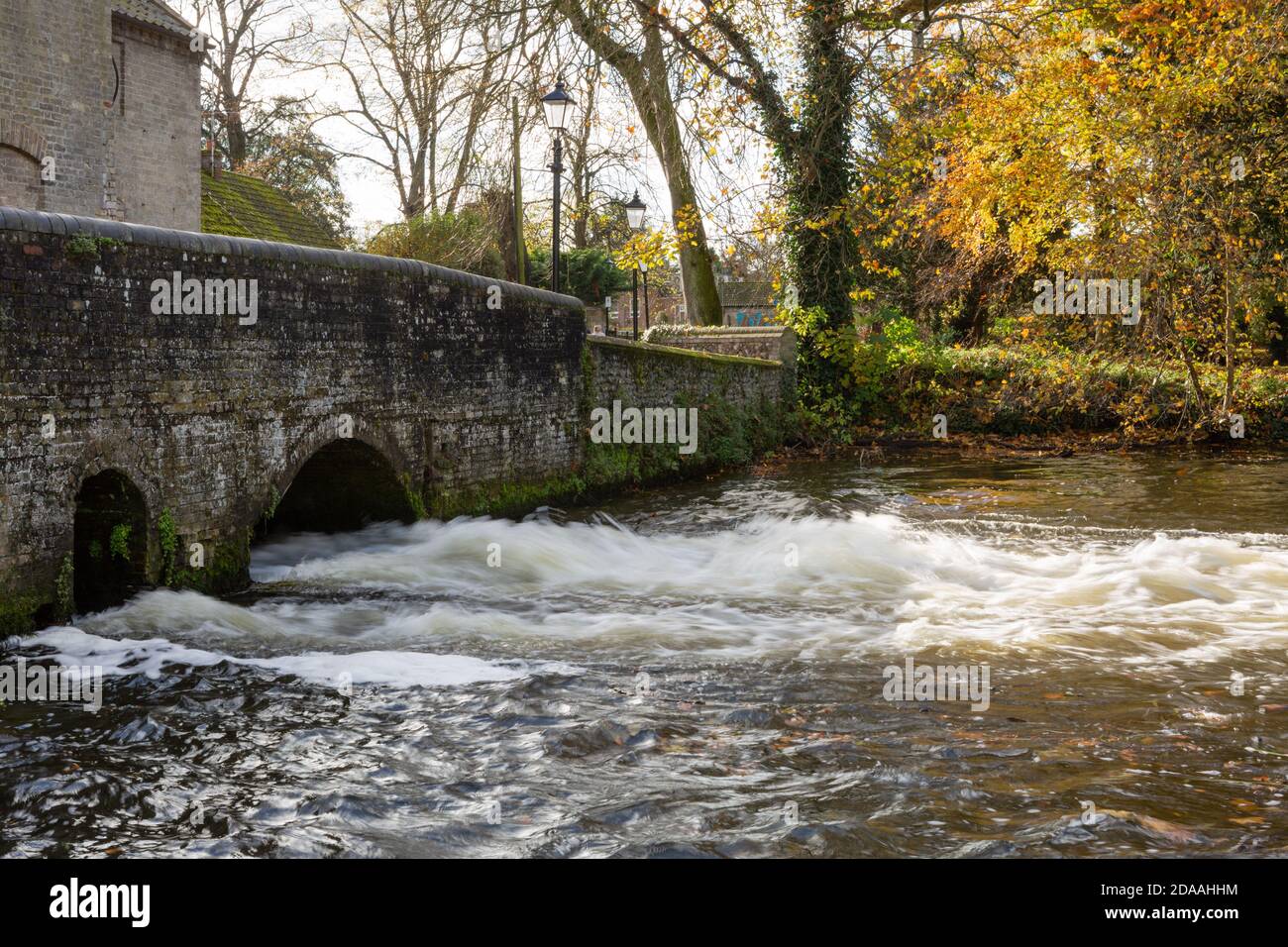 Water flowing under the arches of the former coffee mill on the River ...