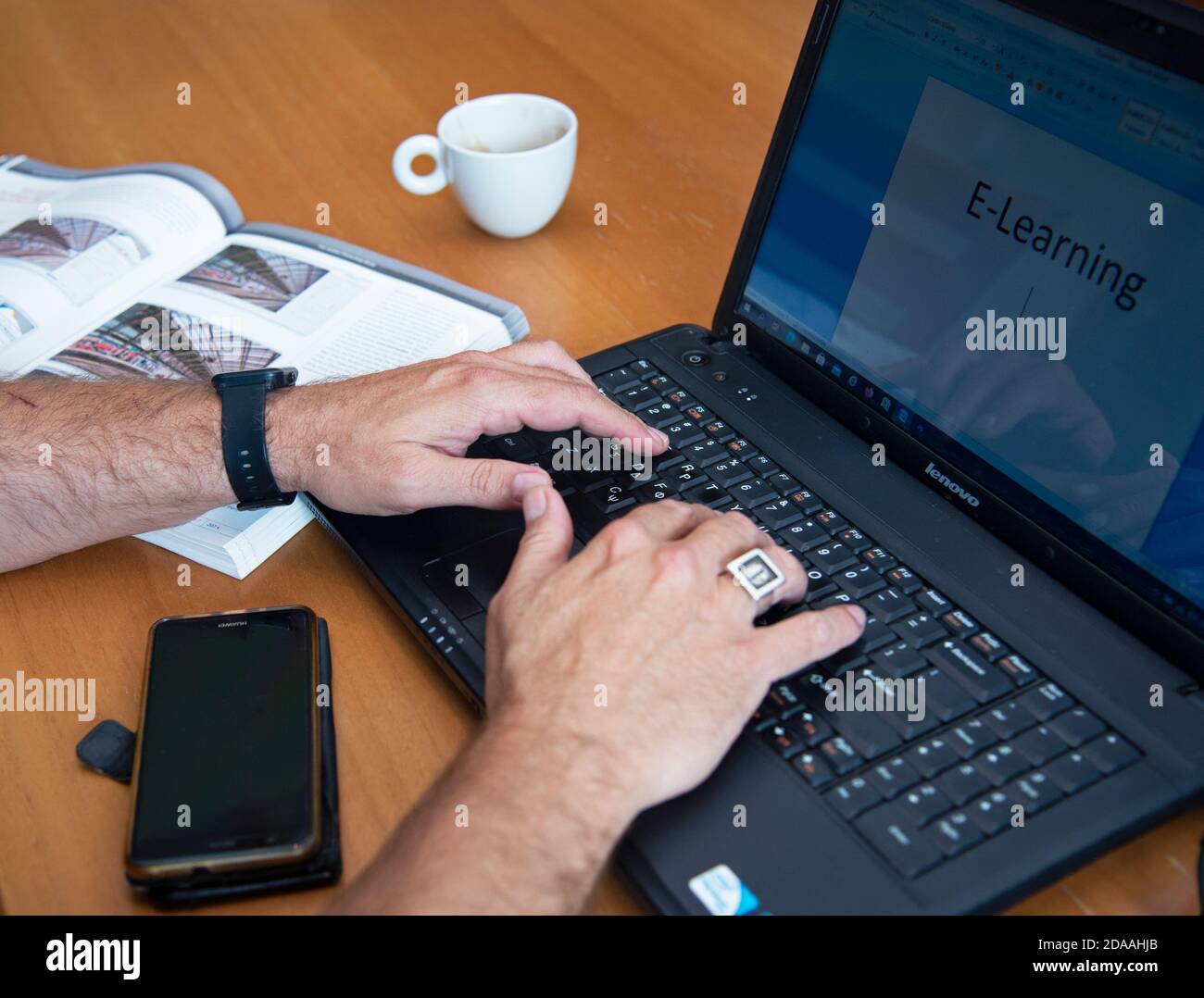 Middle aged man using a laptop computer for a distance learning course ...