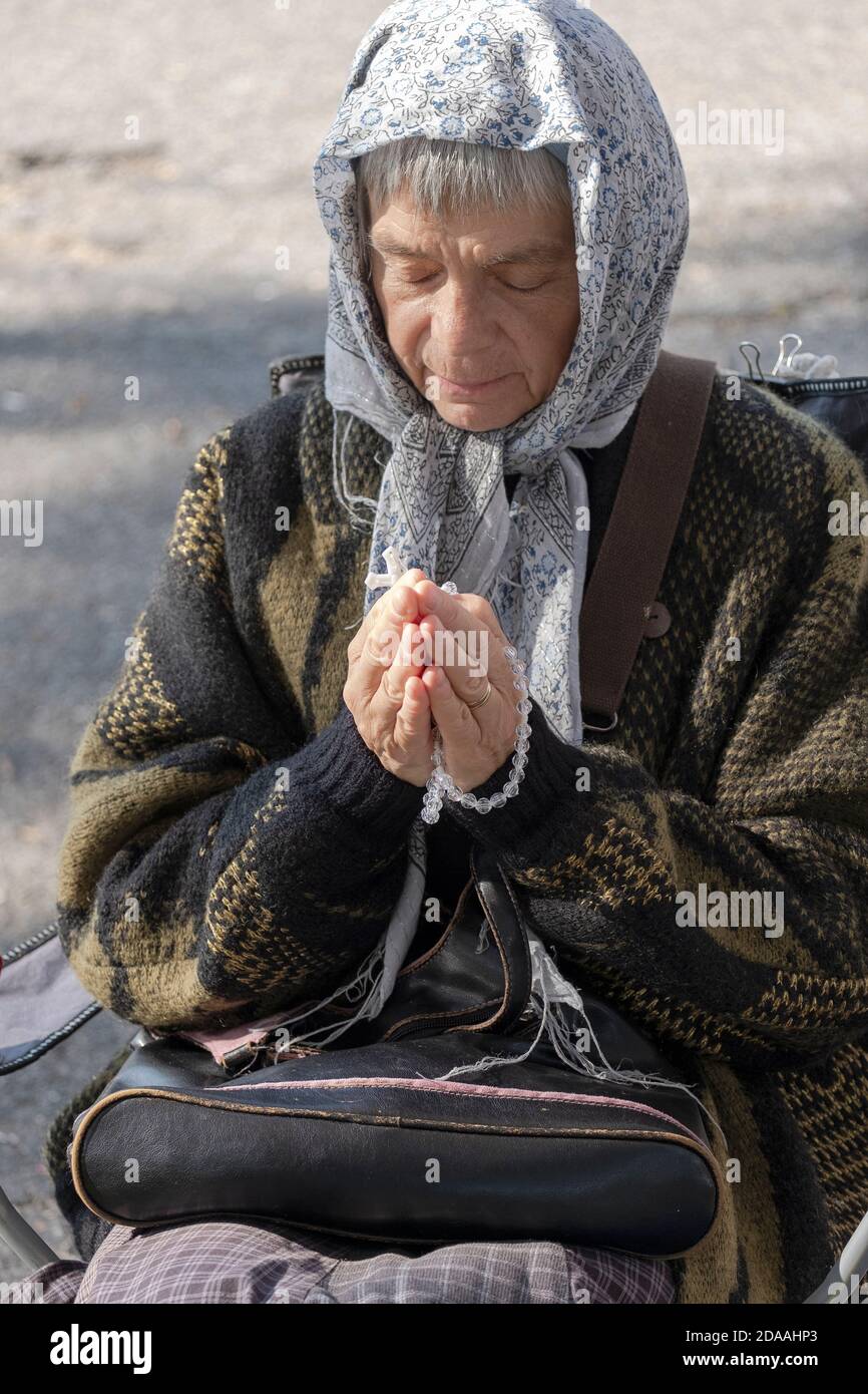 Devout Roman Catholic woman prays at the Vatican Pavilion site in ...