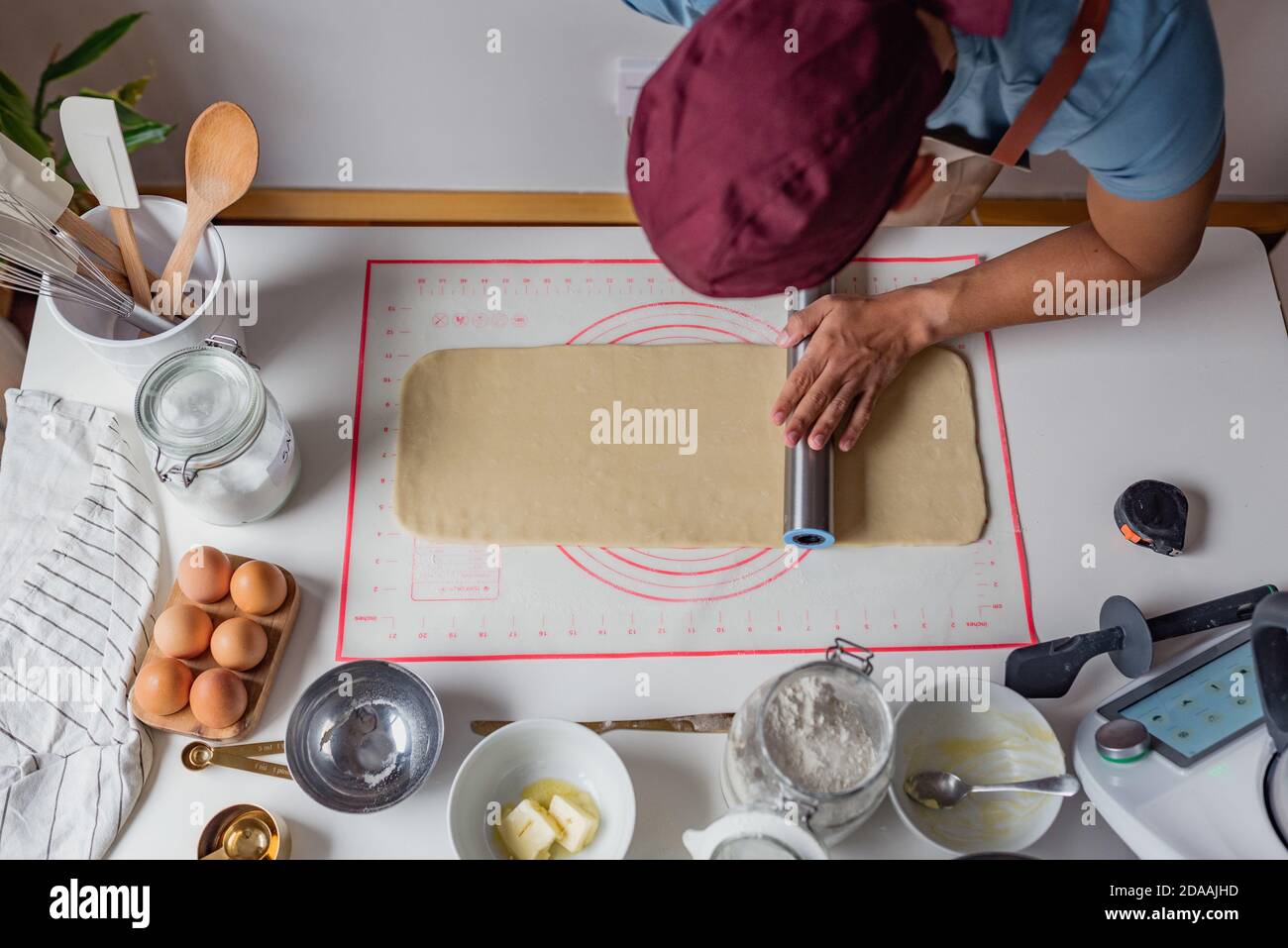 Man kneading dough over a white table Stock Photo - Alamy