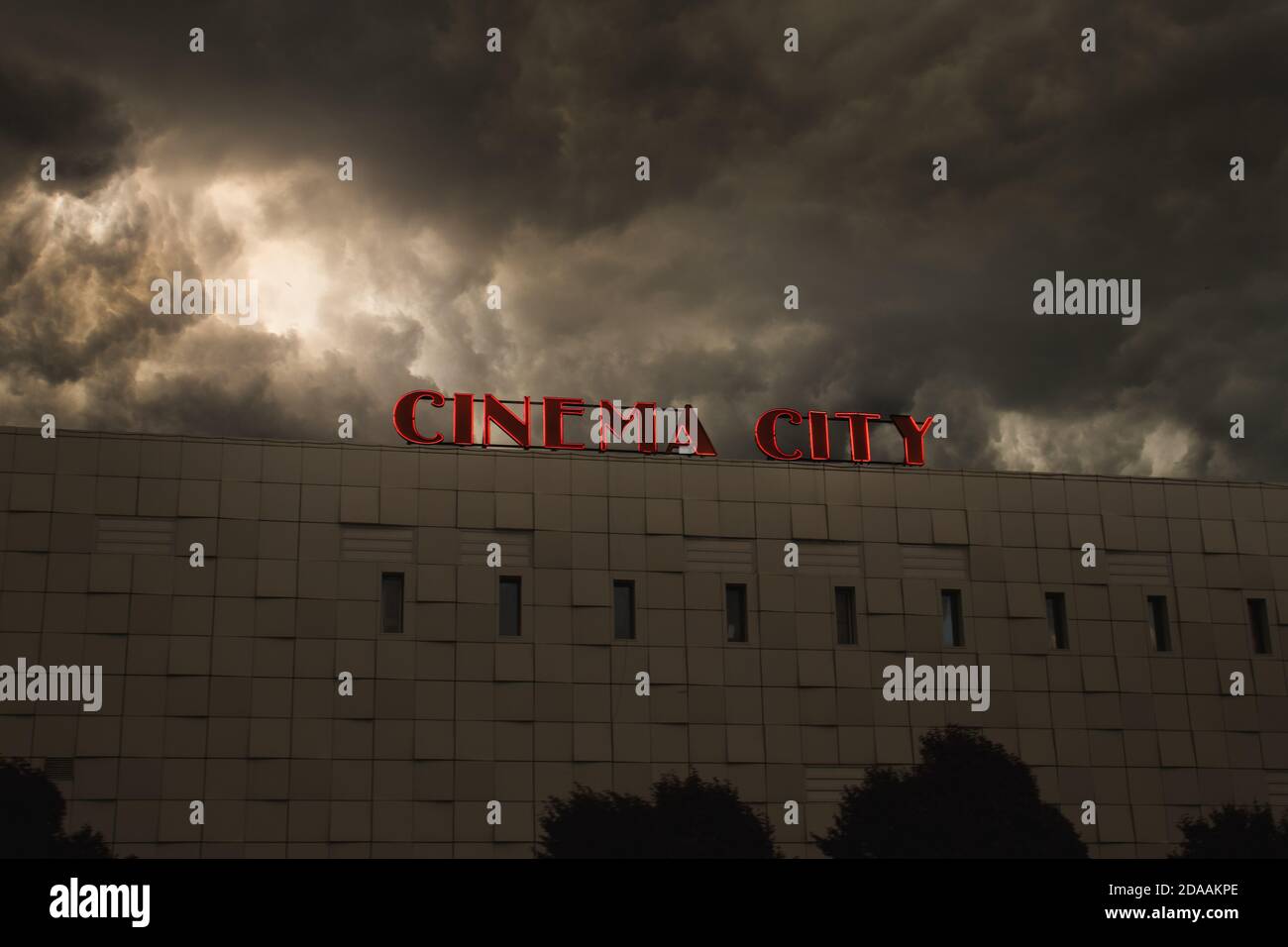 Cinema building, movies, dramatic clouds as background Stock Photo - Alamy