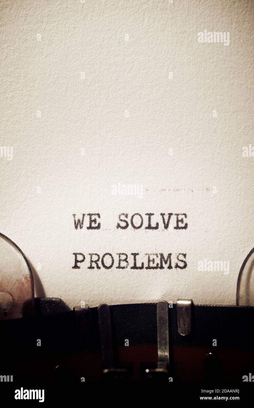 We solve problems phrase written with a typewriter Stock Photo - Alamy