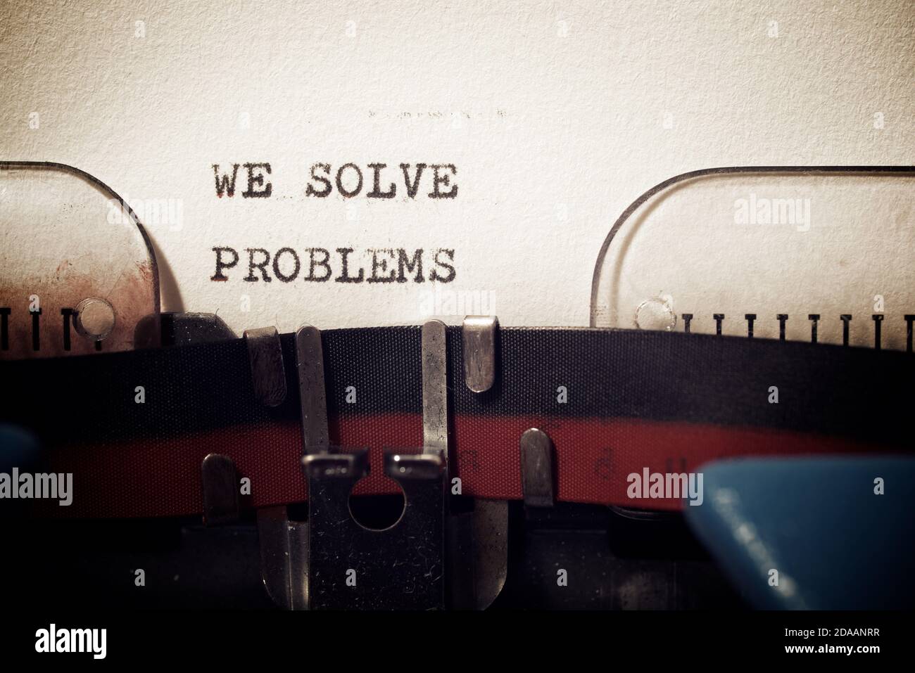We solve problems phrase written with a typewriter Stock Photo - Alamy