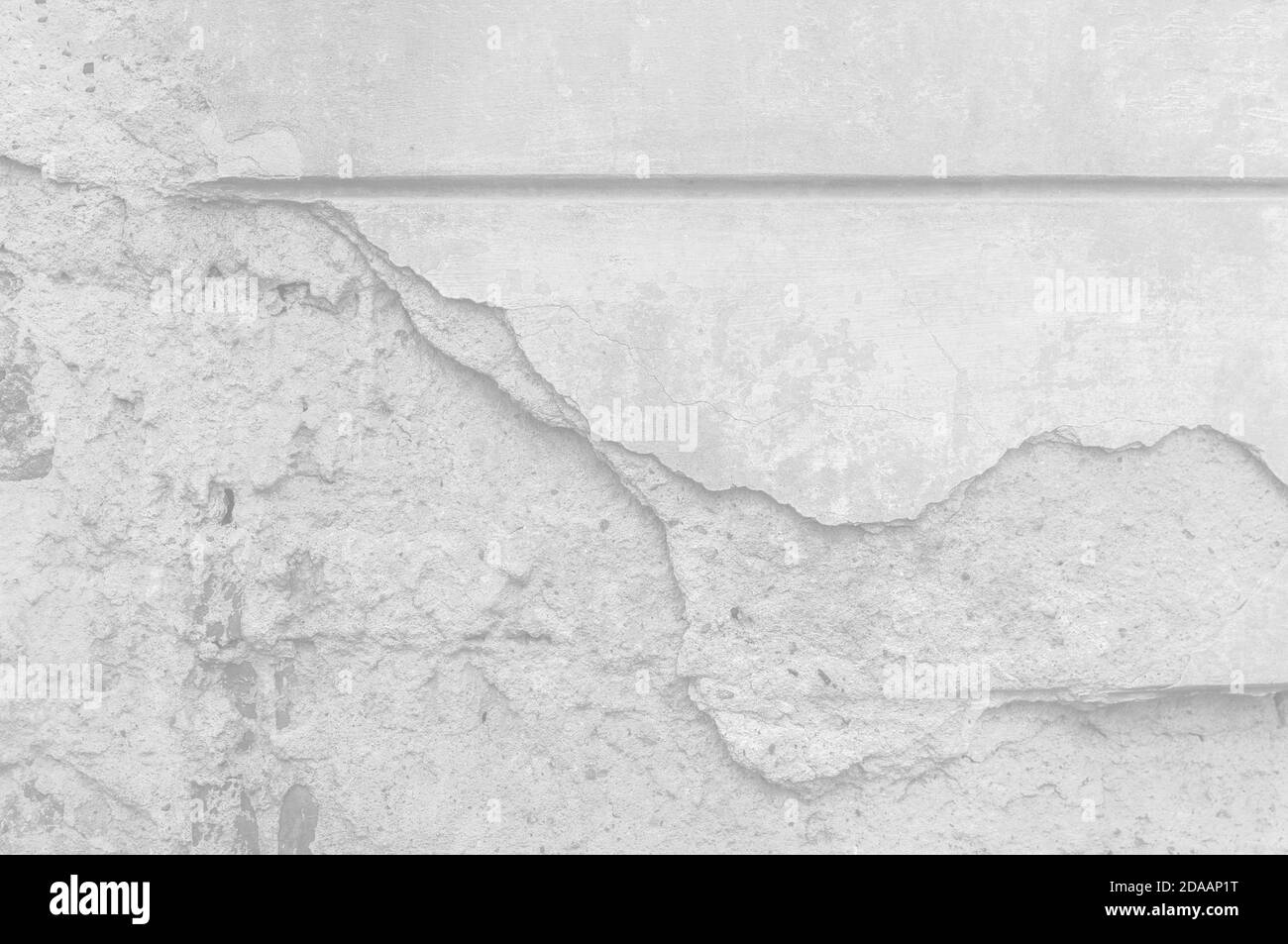 Abstract light gray background. The wall of an old house damaged by age ...