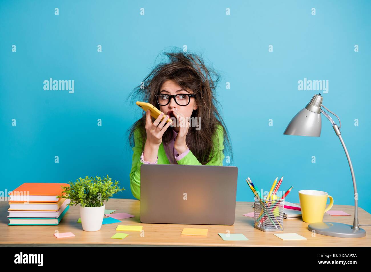 Photo of busy brown messy hair girl sit table use smart call speaker ...
