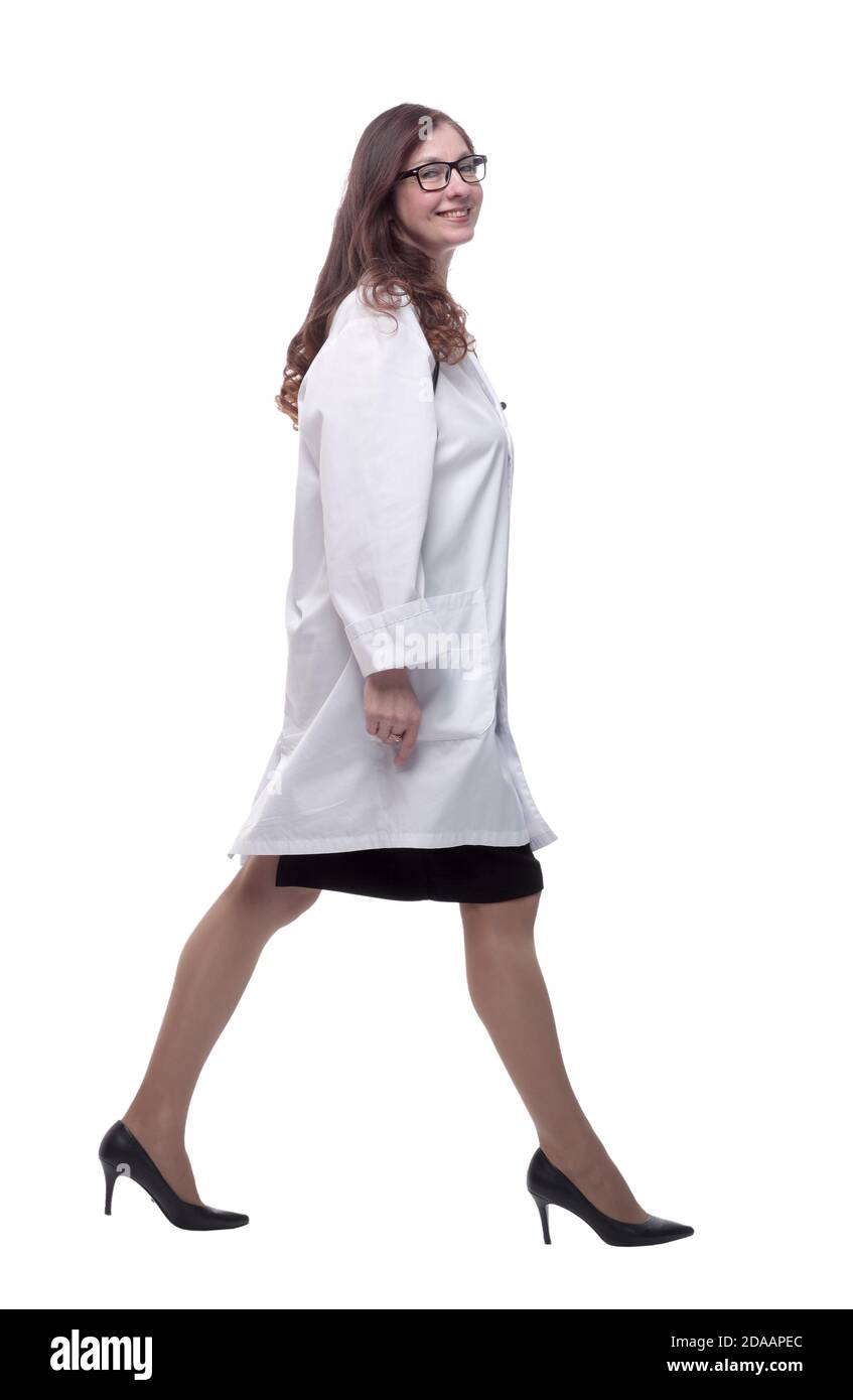 side view. a smiling woman doctor striding forward Stock Photo - Alamy