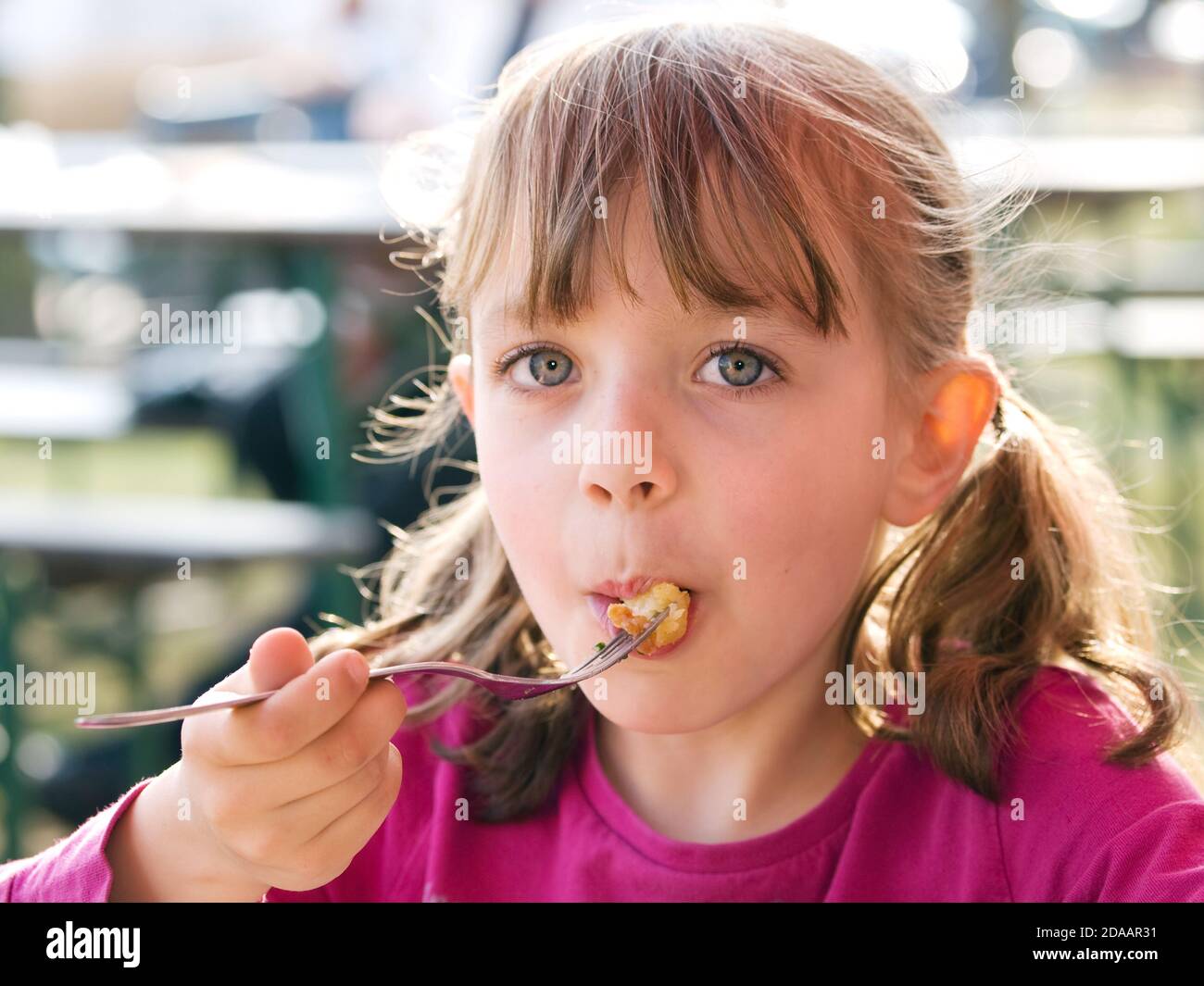 Preschool girl eating snacks Stock Photo - Alamy