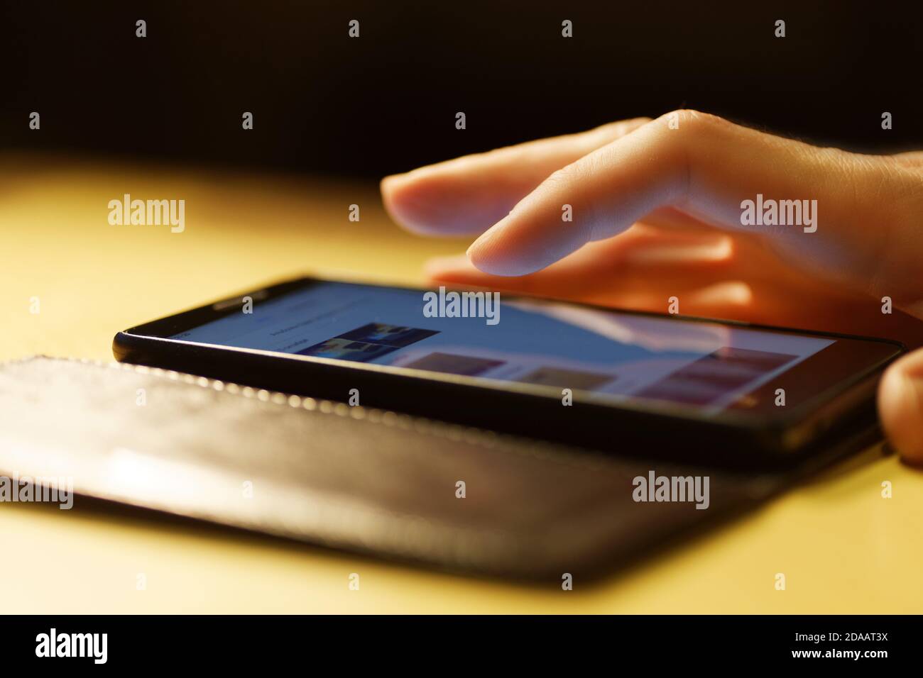 Human hand using smartphone. Finger swipe up and down the screen of ...