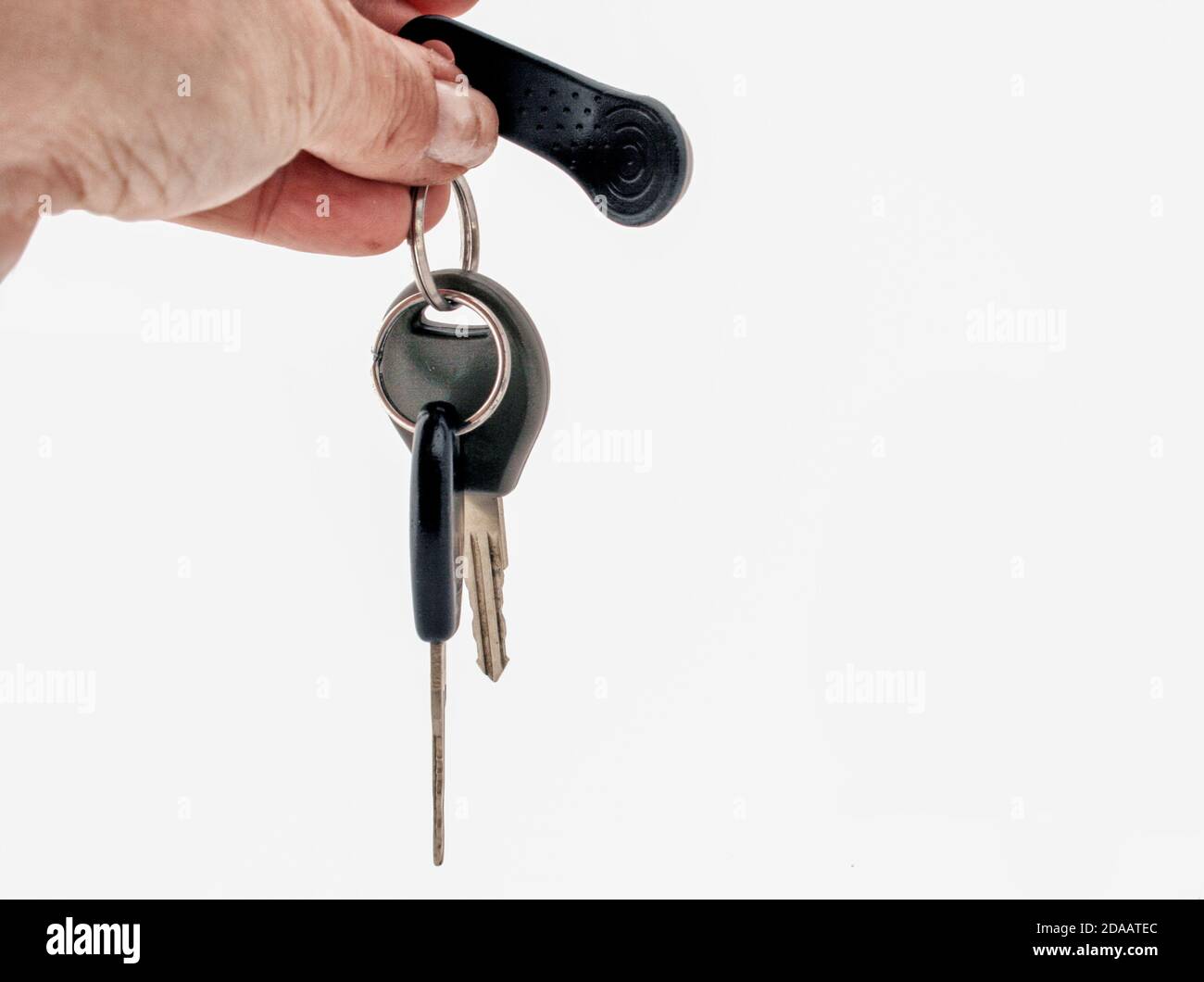 Hand holding two car keys and a safety key Stock Photo - Alamy