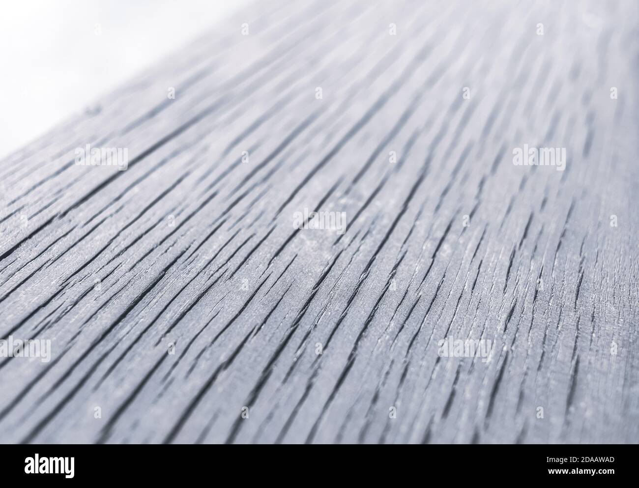Wooden surface of the table with deep cracks. Close-up of an old ...