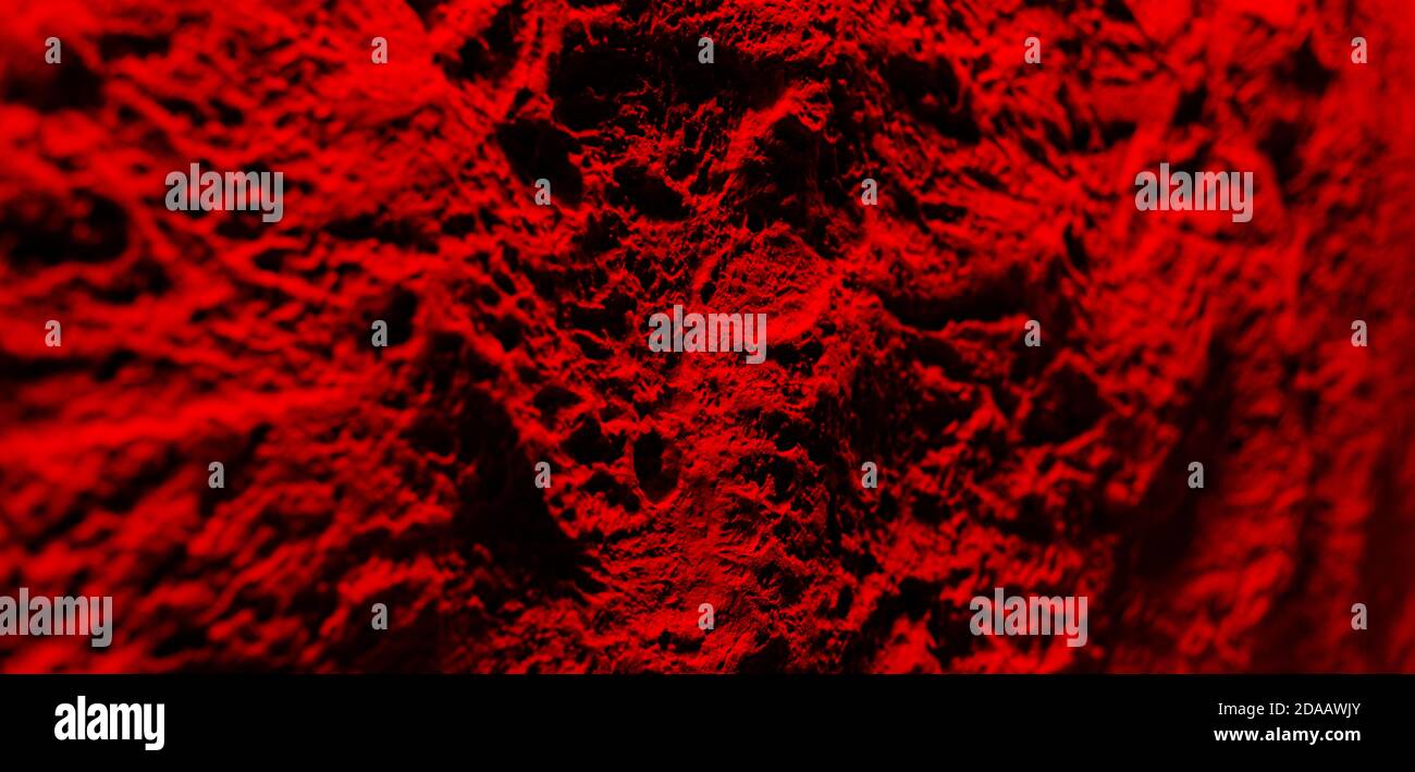Texture of decorative plaster on concrete wall in dramatic red tonality ...