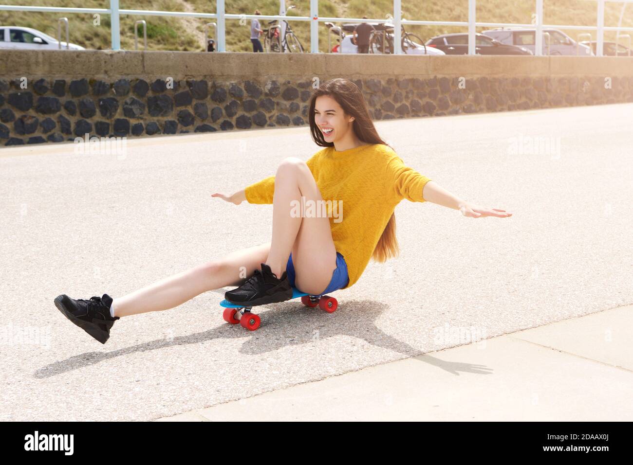 Full body portrait of happy woman balancing on skateboard Stock Photo ...