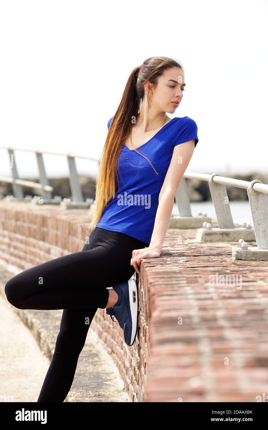 Portrait of attractive sporty woman looking over shoulder Stock Photo ...