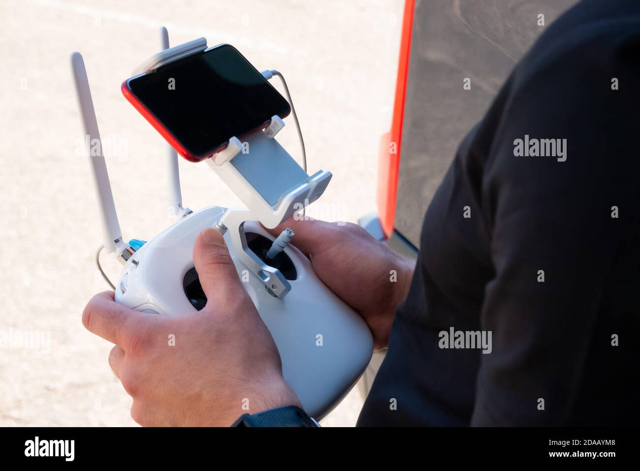 Close up of drone pilot hands controlling aircraft with remote control ...