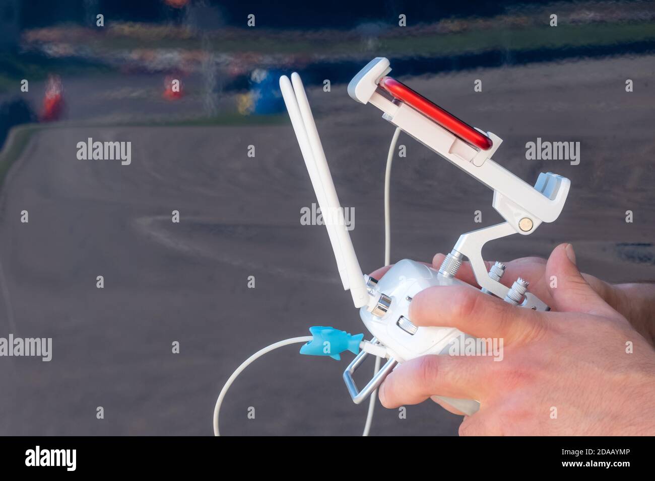 Close up of drone pilot hands controlling aircraft with remote control ...