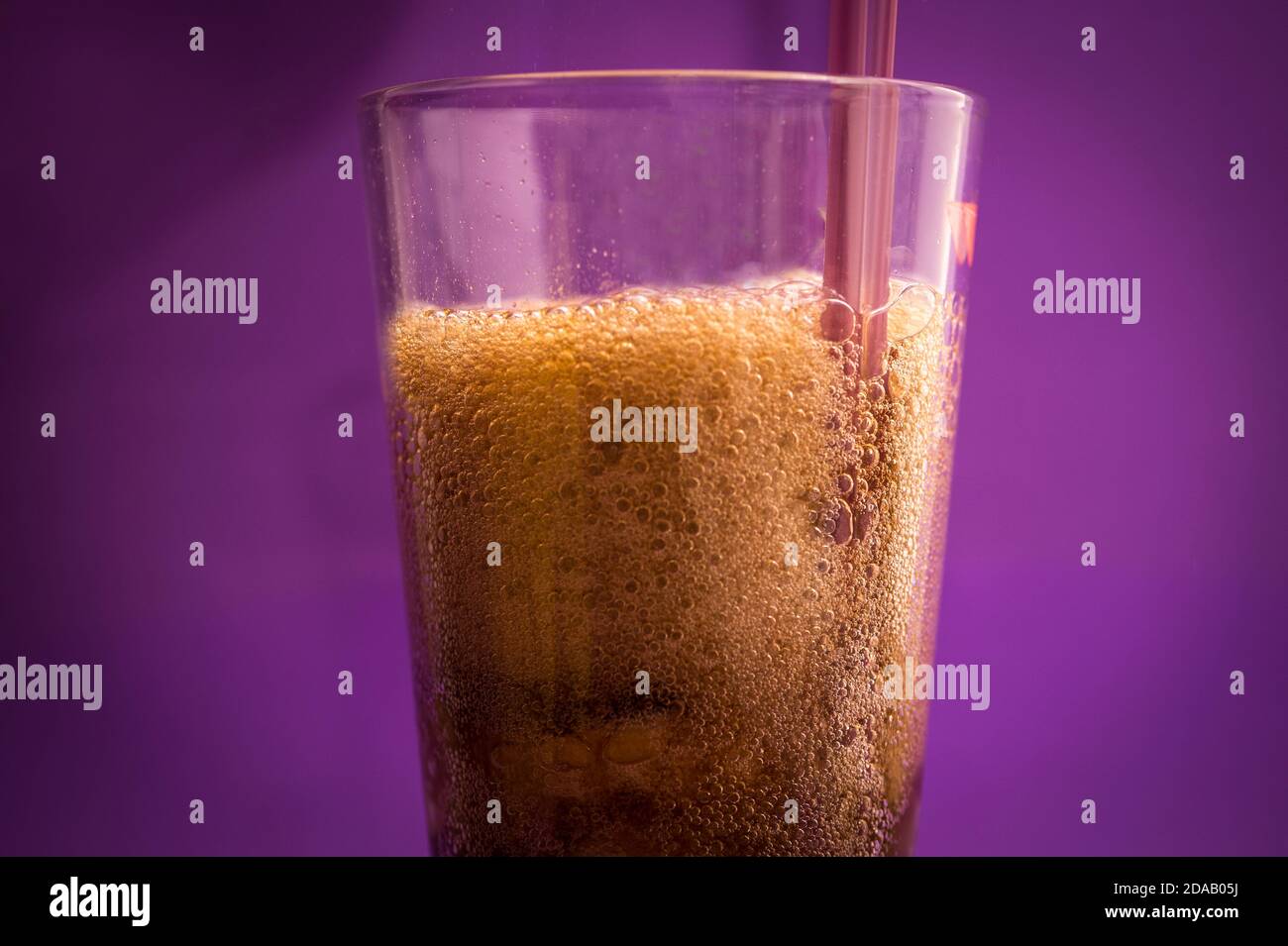 detail of fizzy and carbonated cola drink on purple background Stock ...