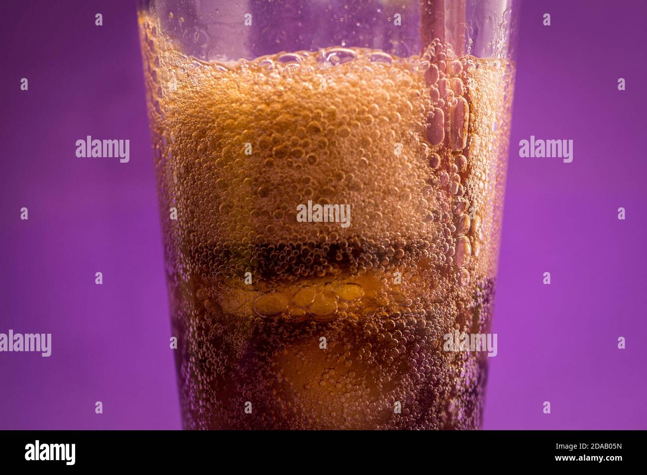 detail of fizzy and carbonated cola drink on purple background Stock ...