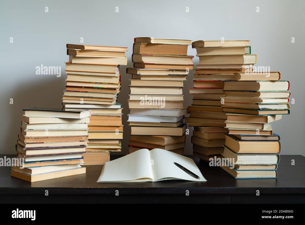 Big stack of books on the table. Studying before the exam. Pile of ...
