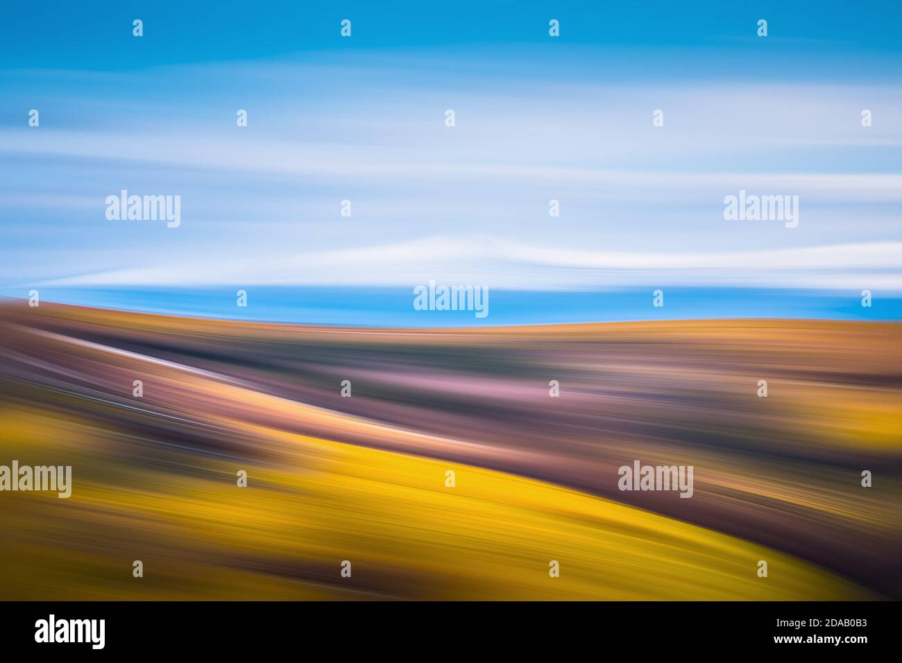 Abstract blurred mountains and blue sky background Stock Photo - Alamy