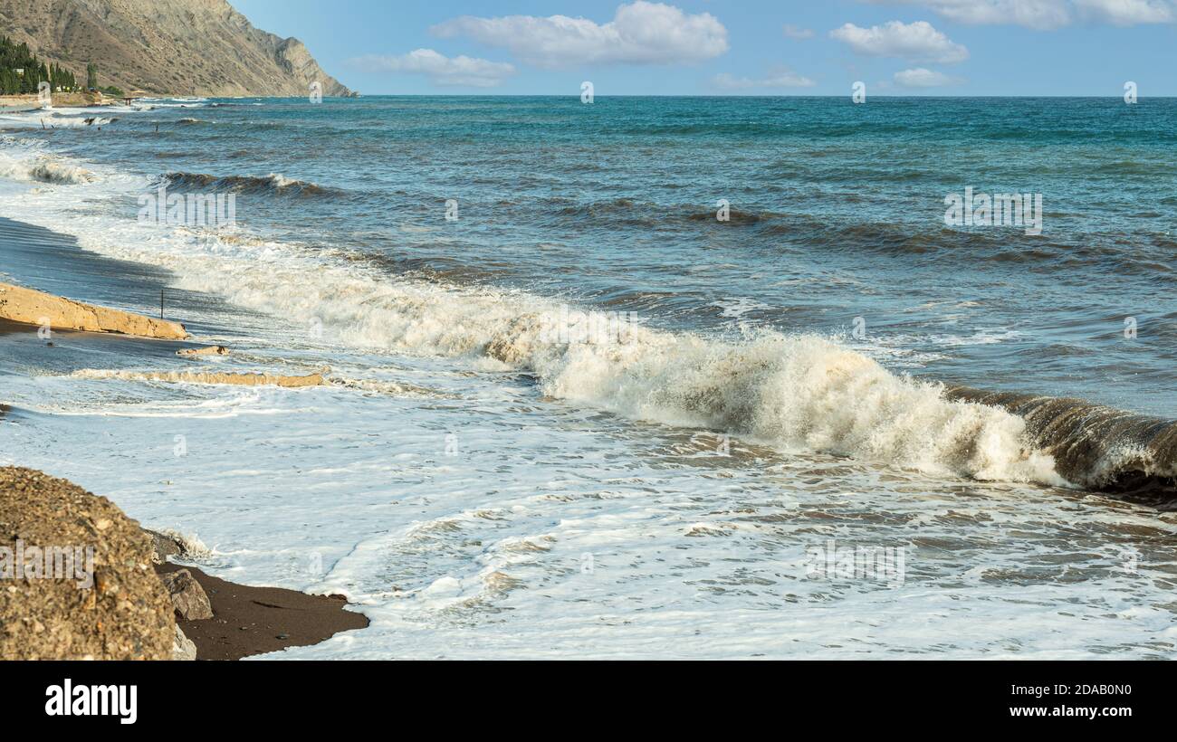 The sea is rough, the wind is blowing, the waves are rolling on a ...