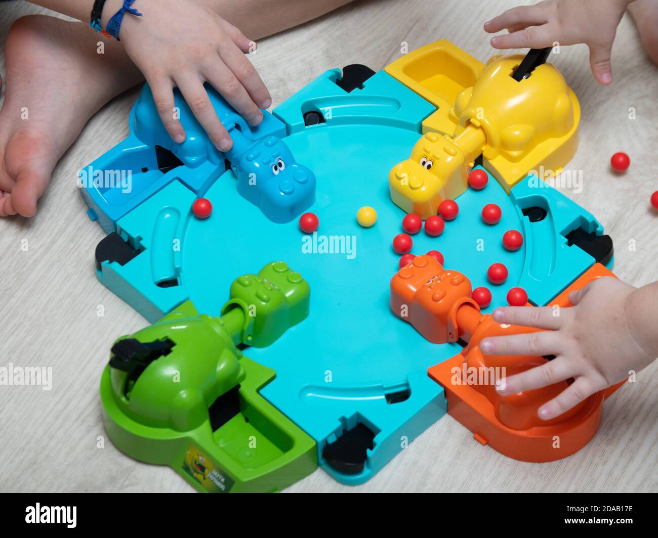 Children play a fun Board game where hippos eat balls. reaction games ...