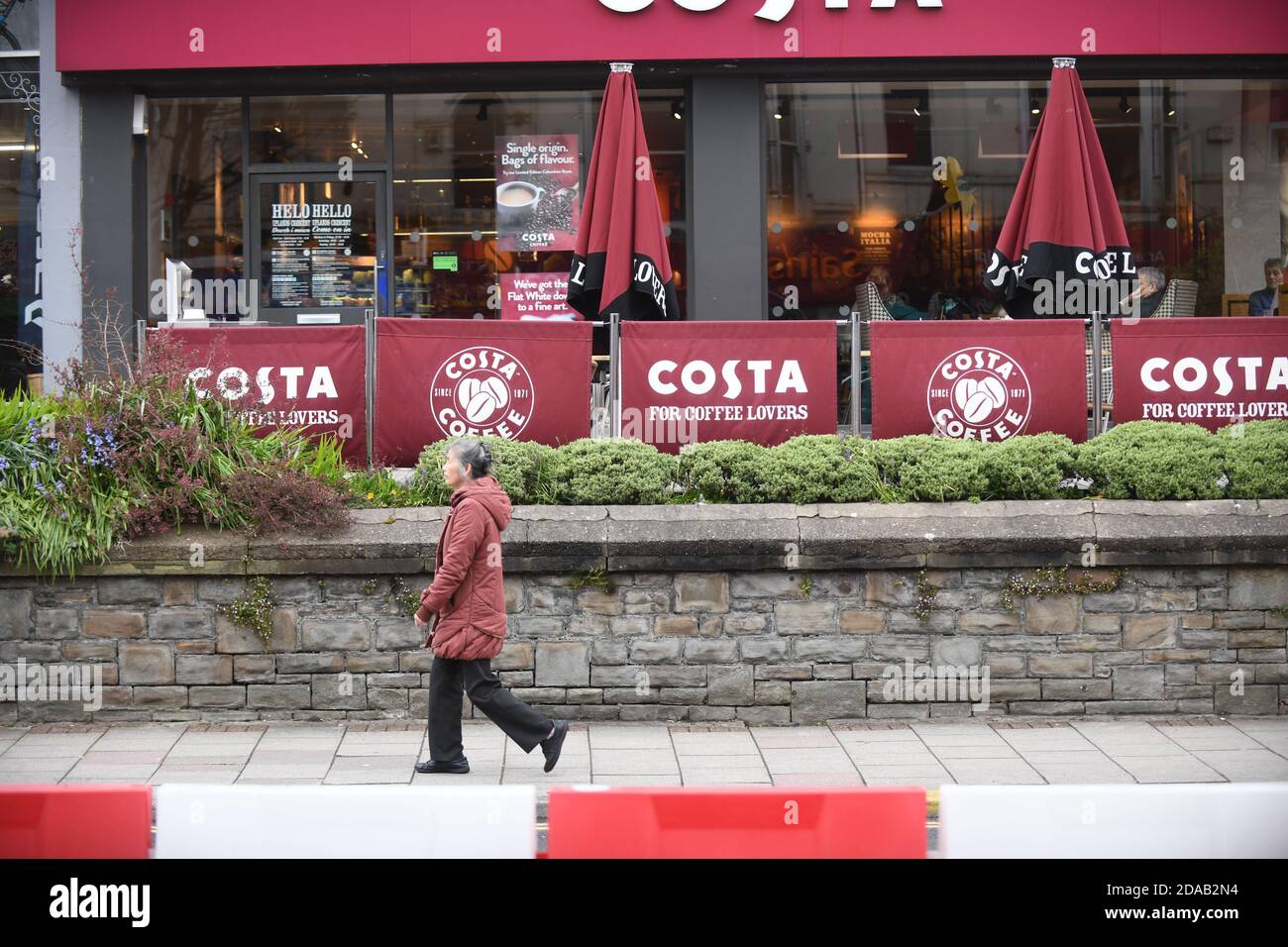A person walks past the outside of a Costa Costa outlet in the UK. The ...