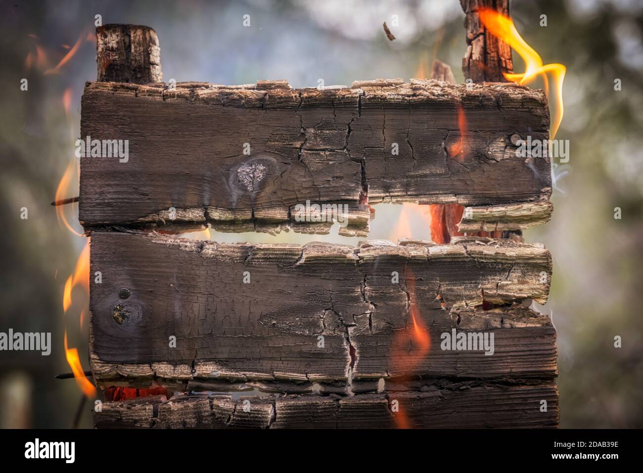 Burning charred wood billboard with copy space Stock Photo - Alamy