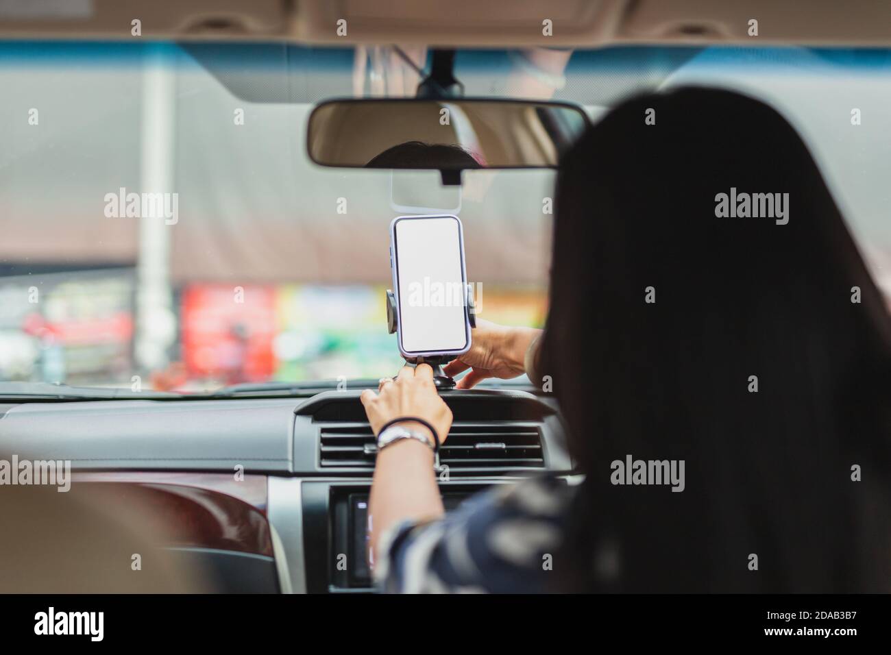 Woman driver hand adjust cell phone for direction Stock Photo - Alamy