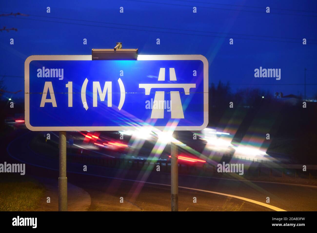 traffic passing A1(M) motorway sign at twilight leeds yorkshire united ...
