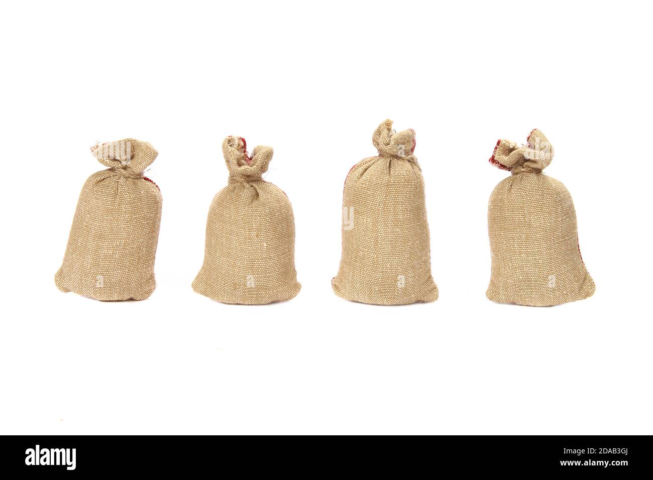 Row of cloth bags isolated on white background Stock Photo - Alamy