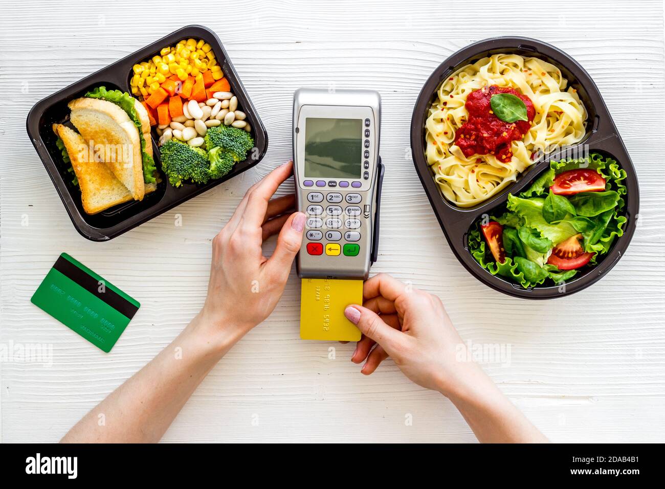 Hands with credit card and payment terminal. Restaurant food delivery ...