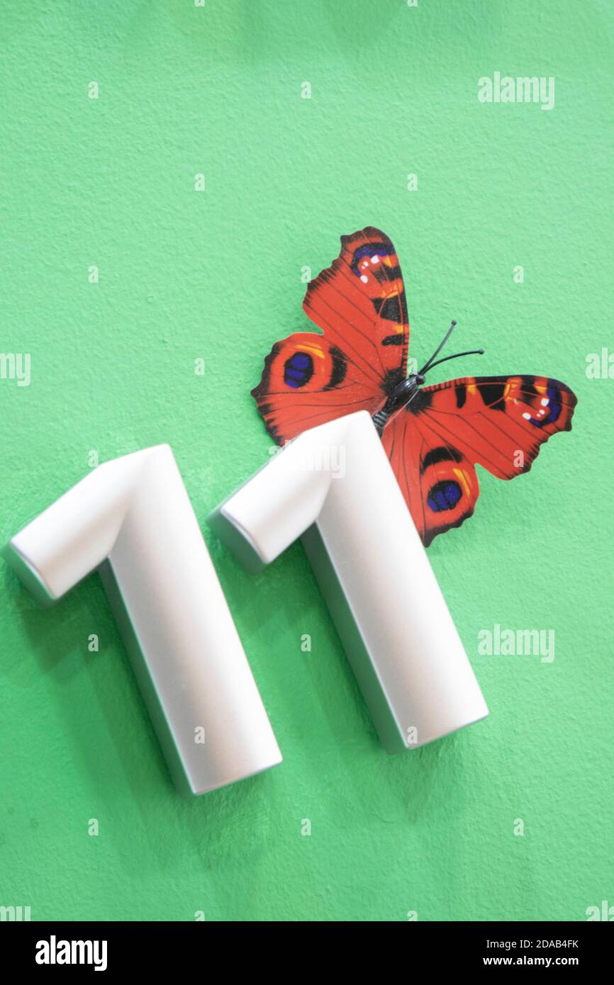 Numbers on green background with red butterfly Stock Photo - Alamy