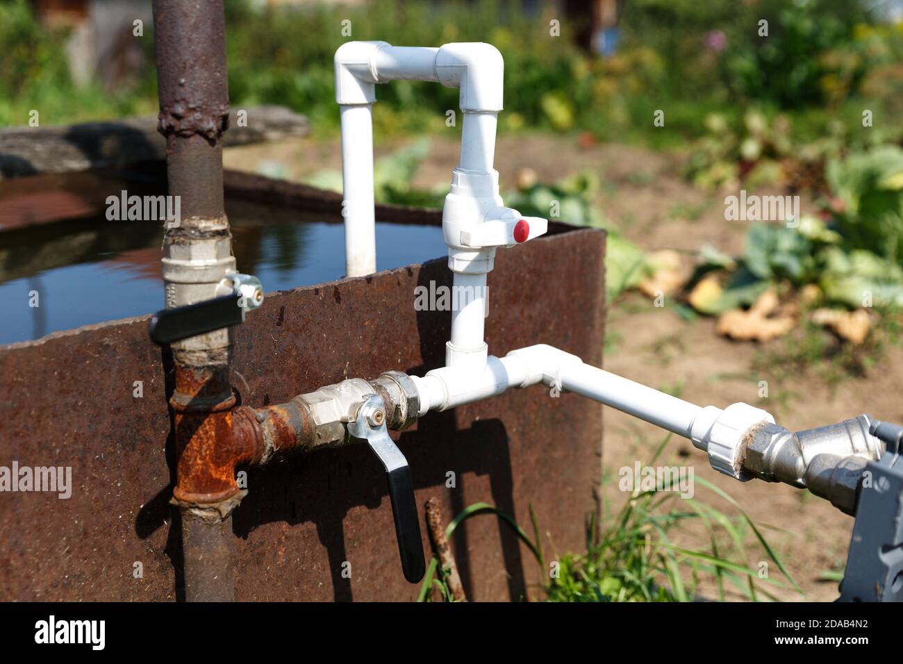 Connection of plastic pipes to the pump and water storage tank. Pumping ...