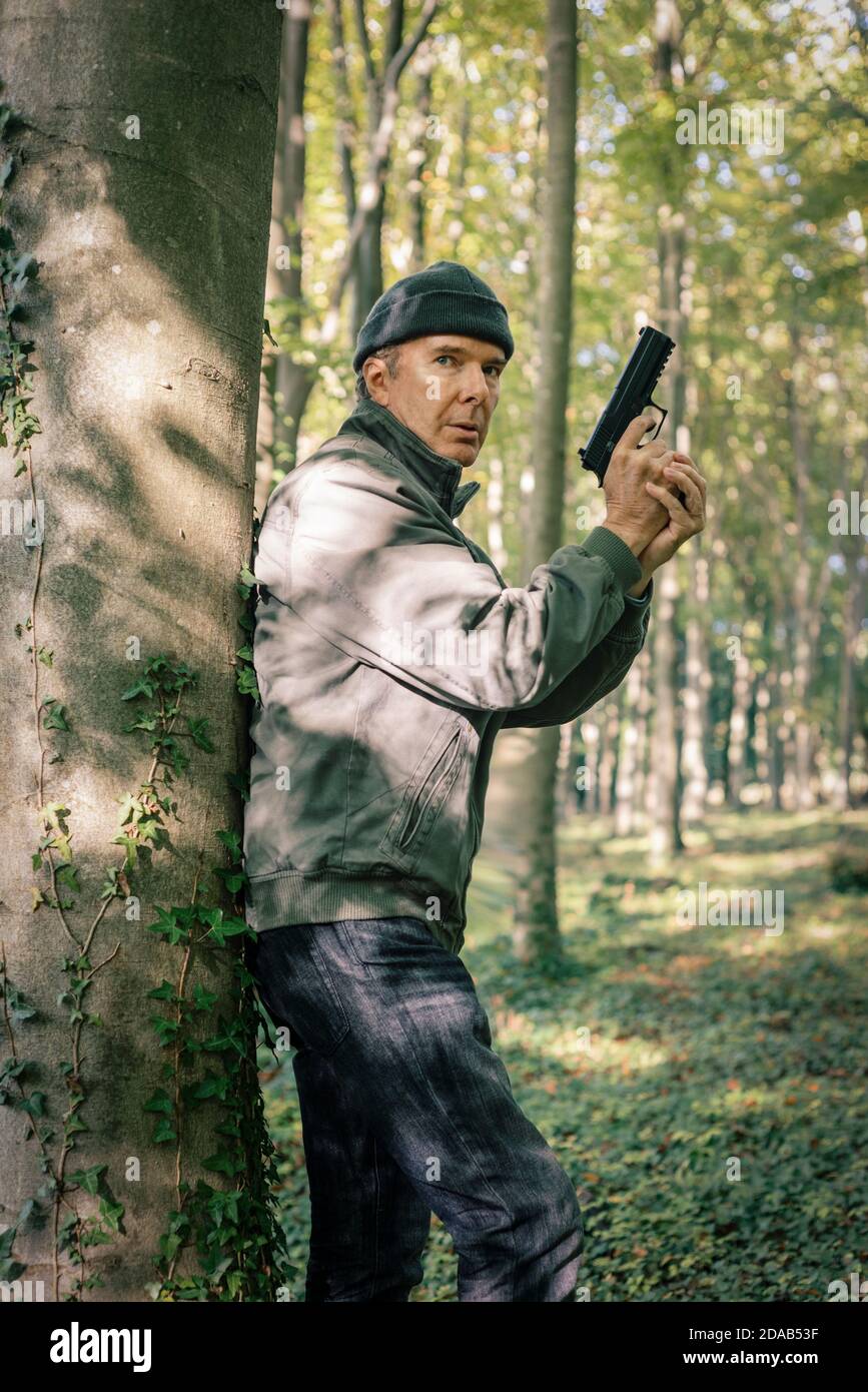 Man holding a gun hi-res stock photography and images - Alamy