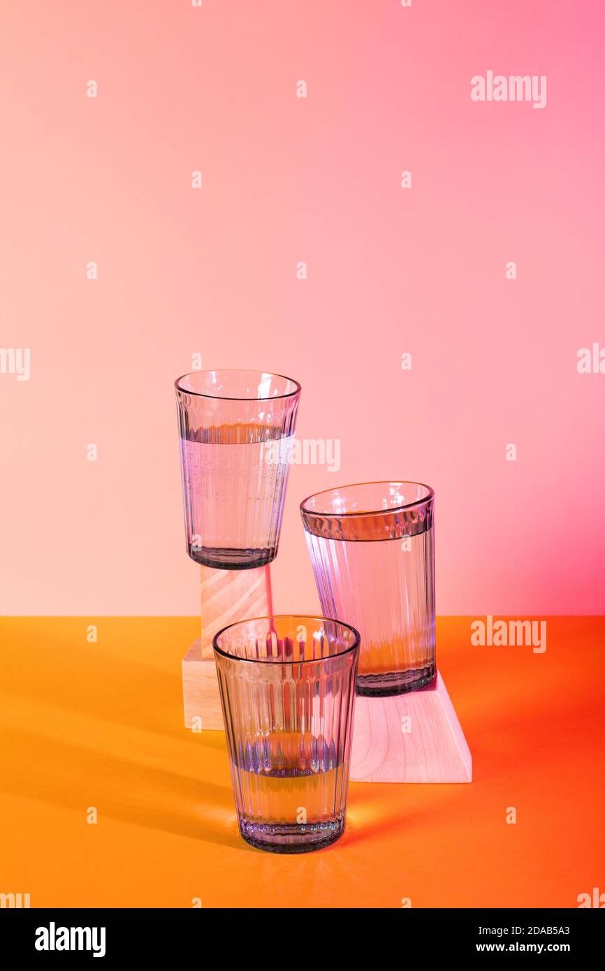 Bright summer design concept with clear water. Pour water into a glass ...