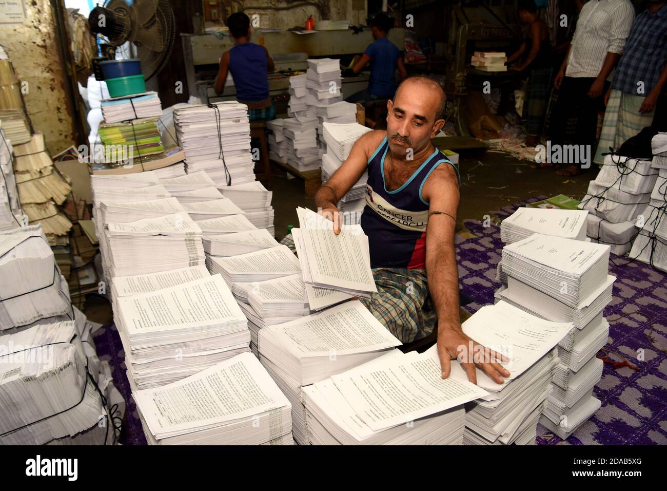 Bangladeshi worker works in a book binding factory in Dhaka City in ...