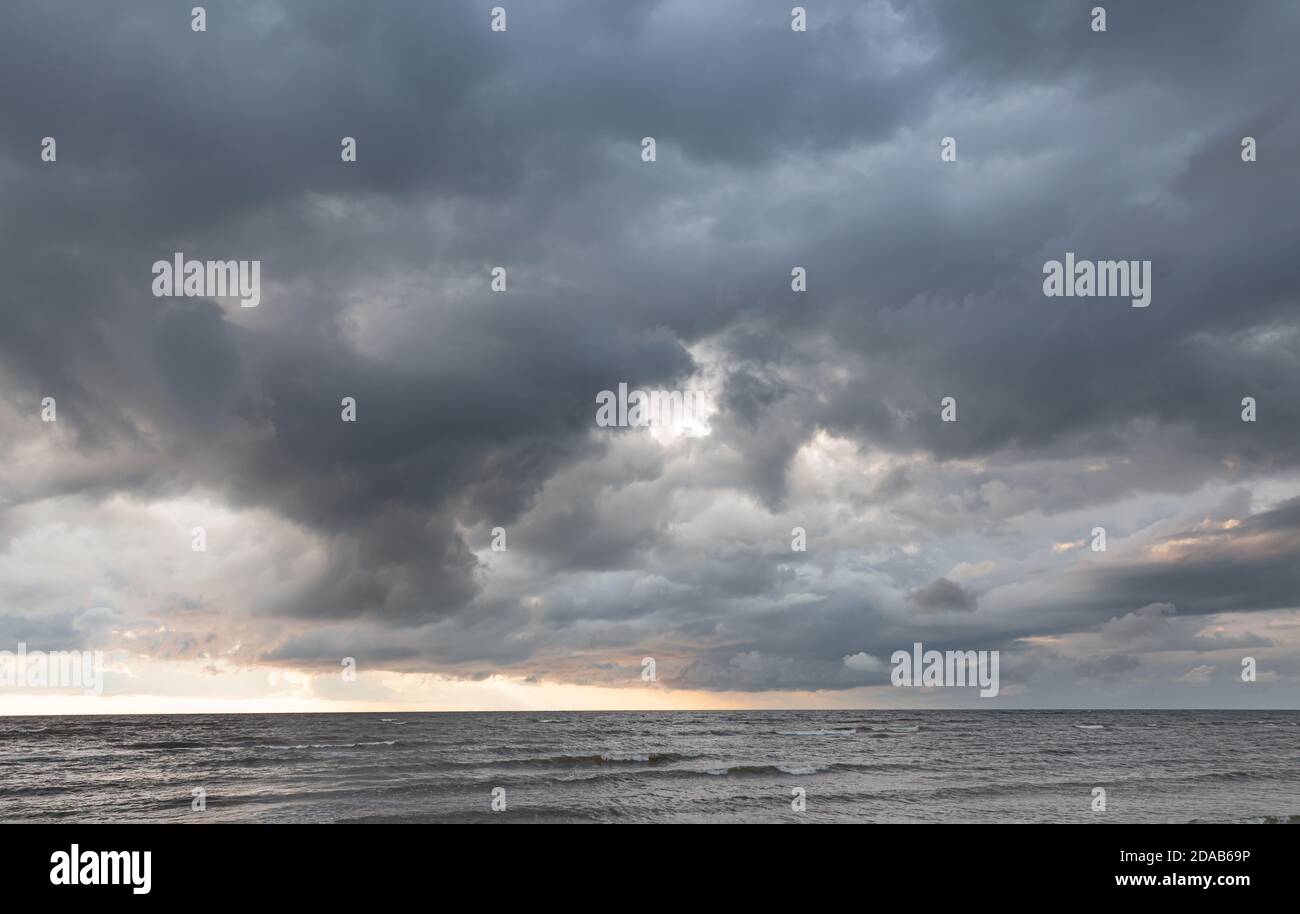Amazing dramatic landscape. Dramatic dark clouds during sunset at sea ...