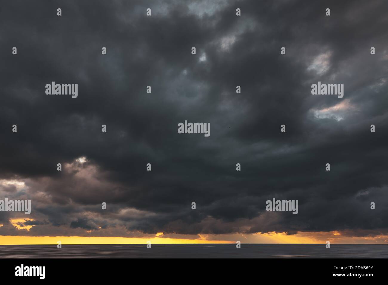 Amazing dramatic landscape. Dramatic dark clouds during sunset at sea ...