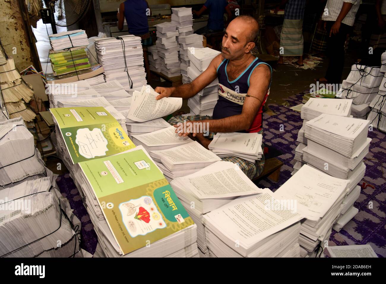 Bangladeshi worker works in a book binding factory in Dhaka City in ...