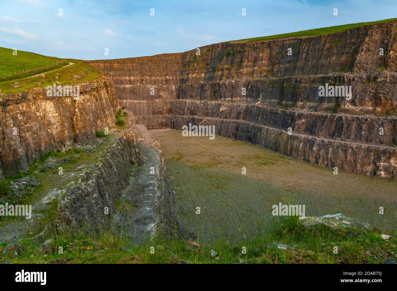 Steep benches of excavated limestone in the abandoned Eldon HIll Quarry ...