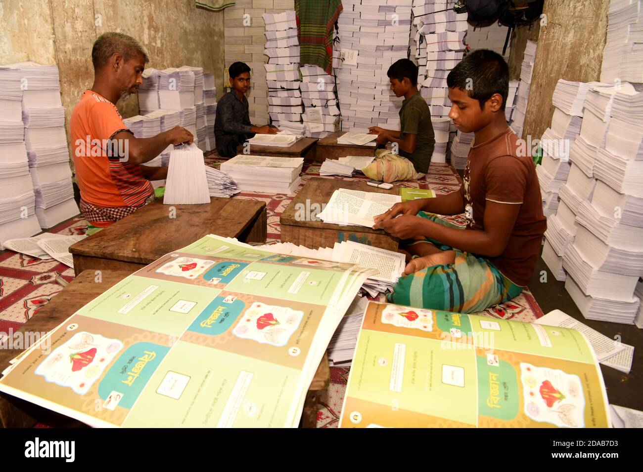 Bangladeshi child worker works in a book binding factory in Dhaka City ...