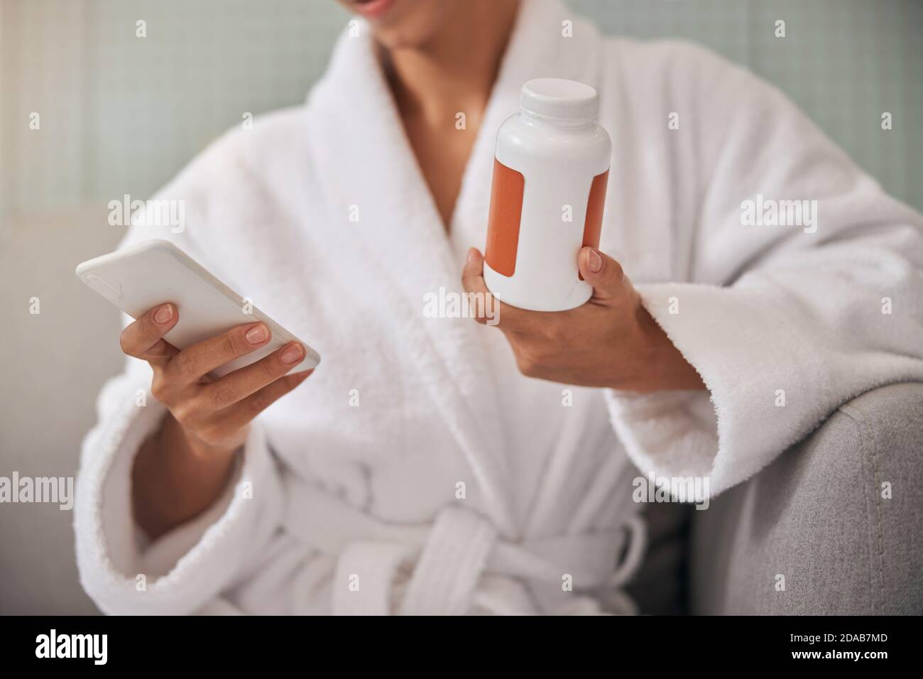Cropped photo of woman without face holding a telephone and pills Stock ...
