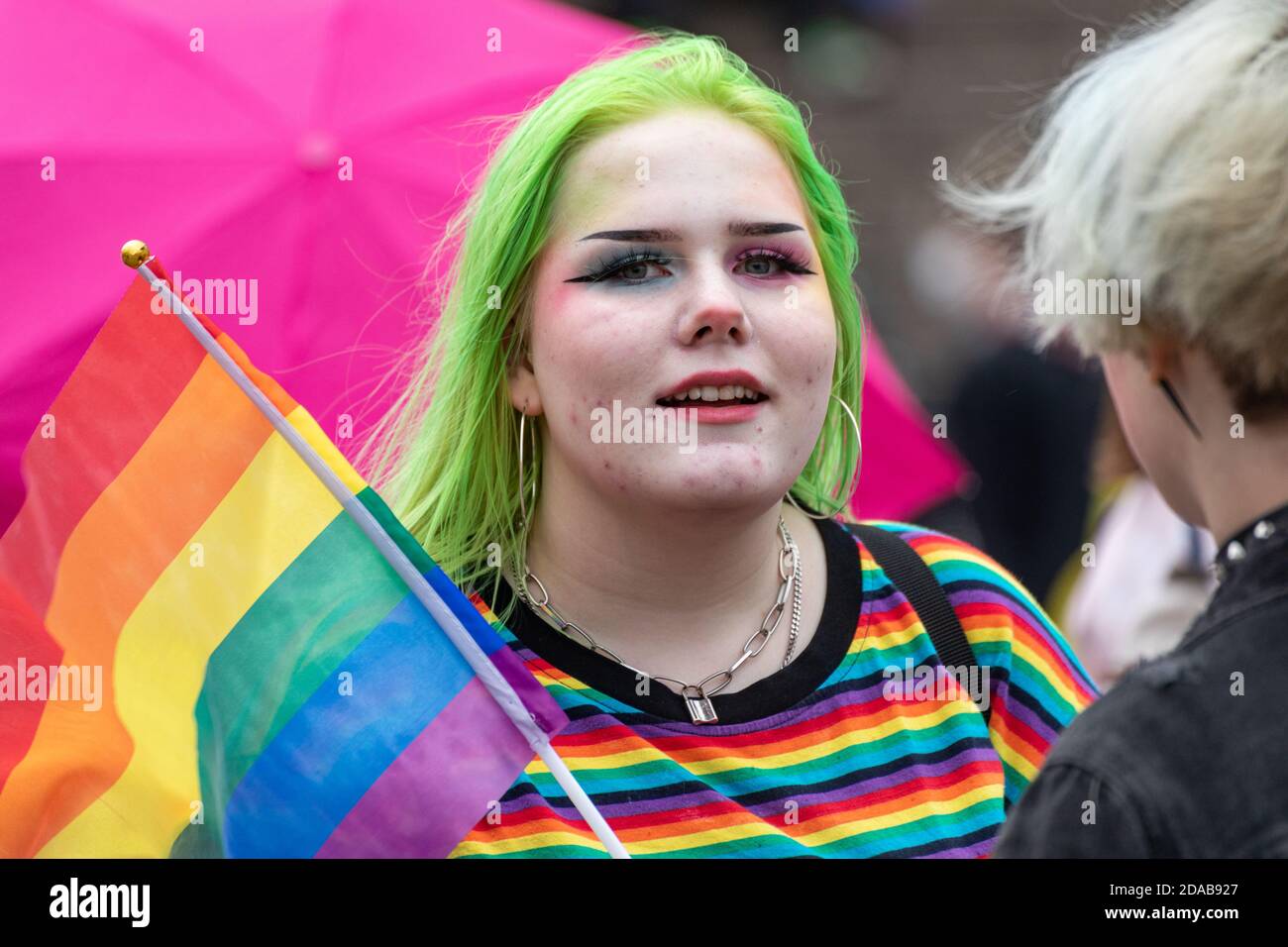Young woman with green hair and rainbow flag at Helsinki Pride 2020 ...