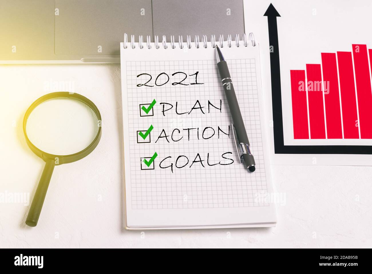 Plan and goals for 2021. Action text in notepad. Worker office desk ...