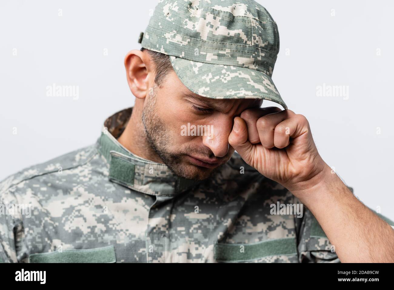 sad military man in uniform and cap wiping tears while crying isolated ...