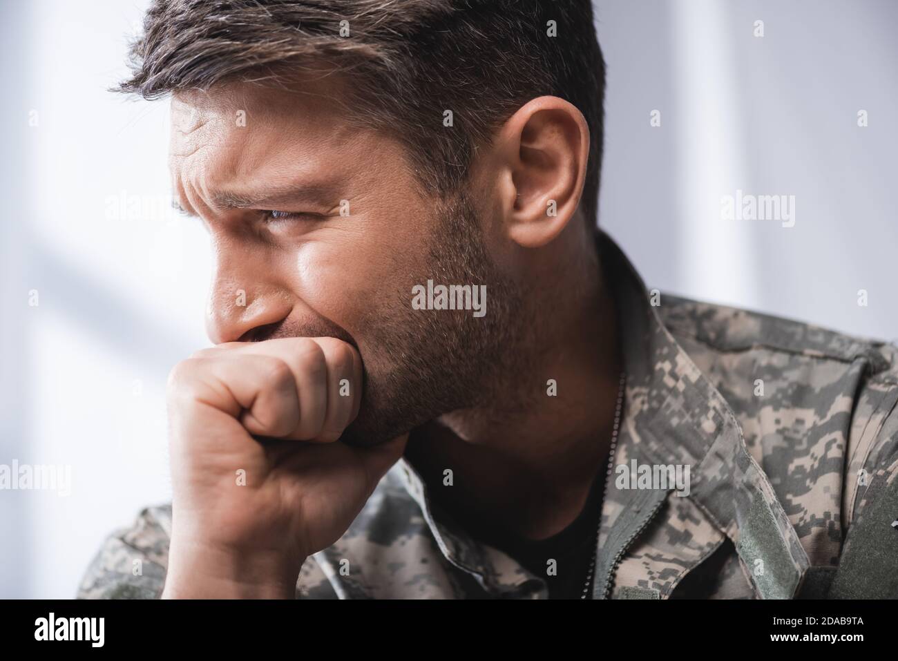 military man in uniform crying and covering mouth with clenched fist ...