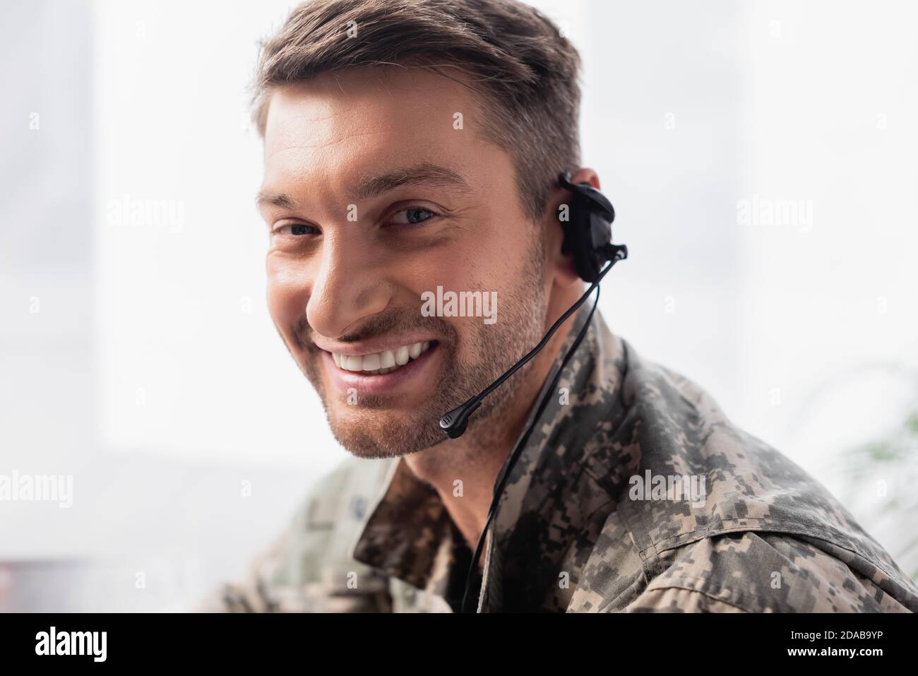 happy military man in uniform and headset smiling in office Stock Photo ...