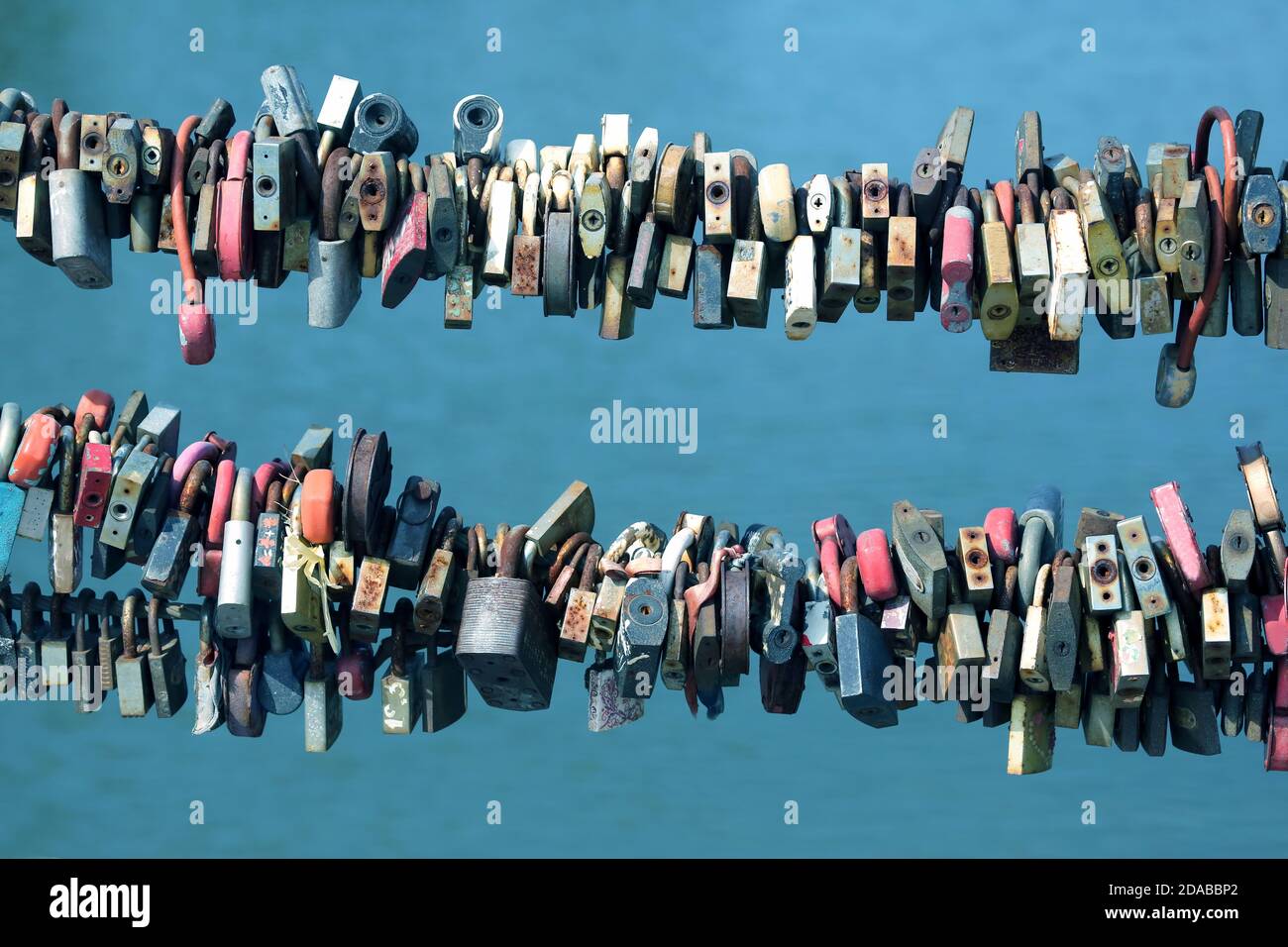 two rows of a large number of wedding locks on the rope Stock Photo - Alamy