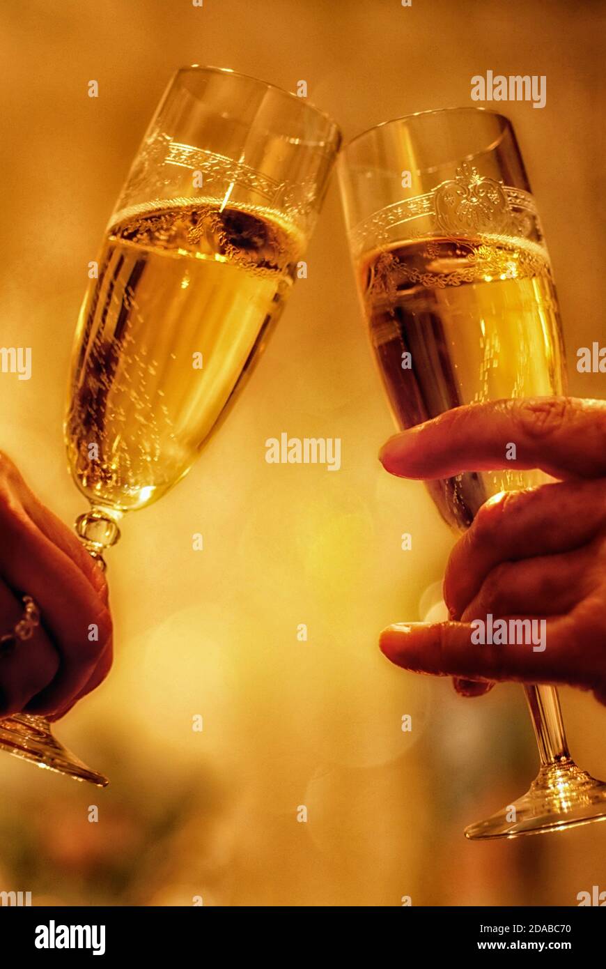 Two people clink glasses at a evening-party Stock Photo - Alamy